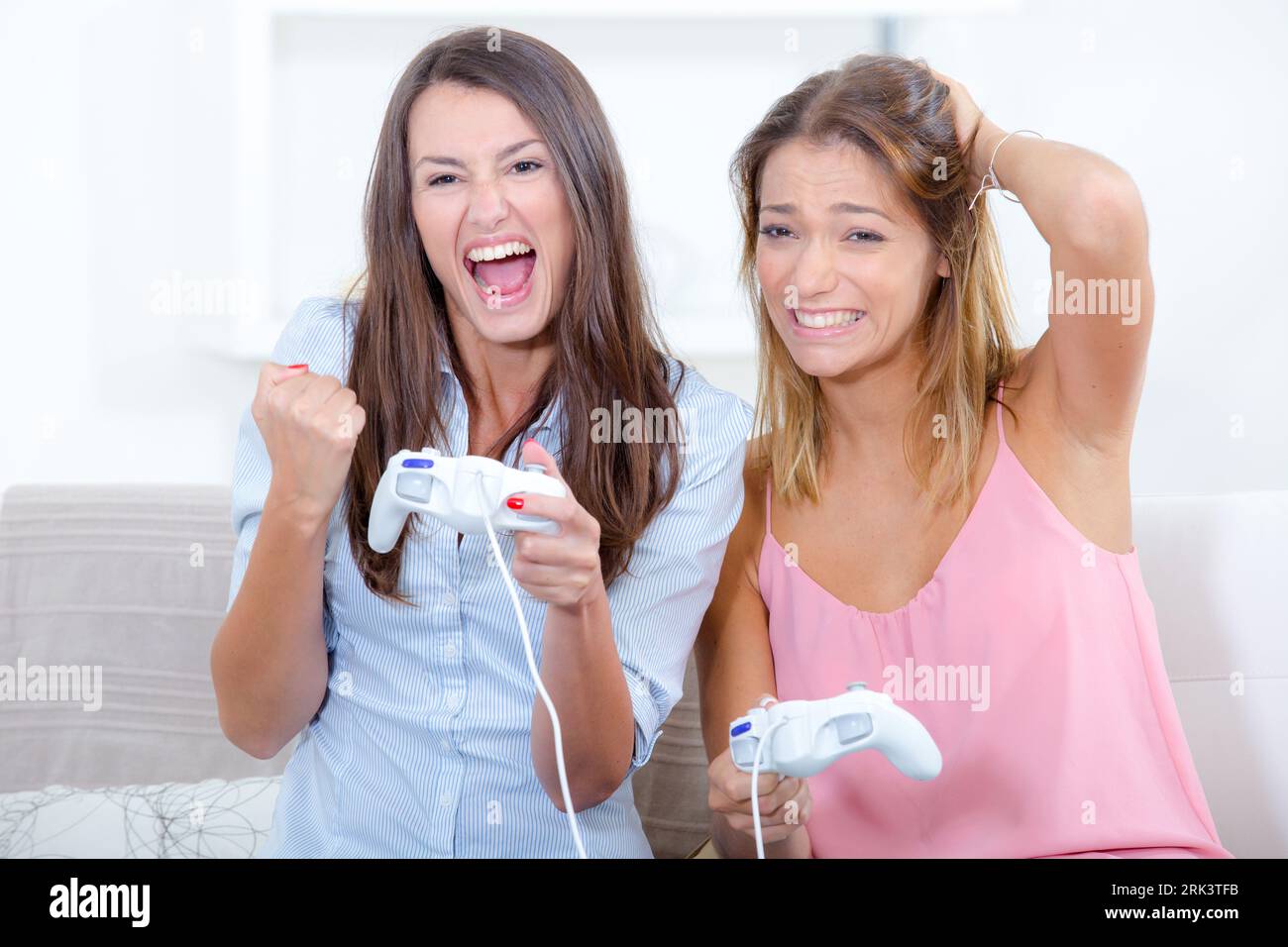 Two friends competing at computer game Stock Photo - Alamy