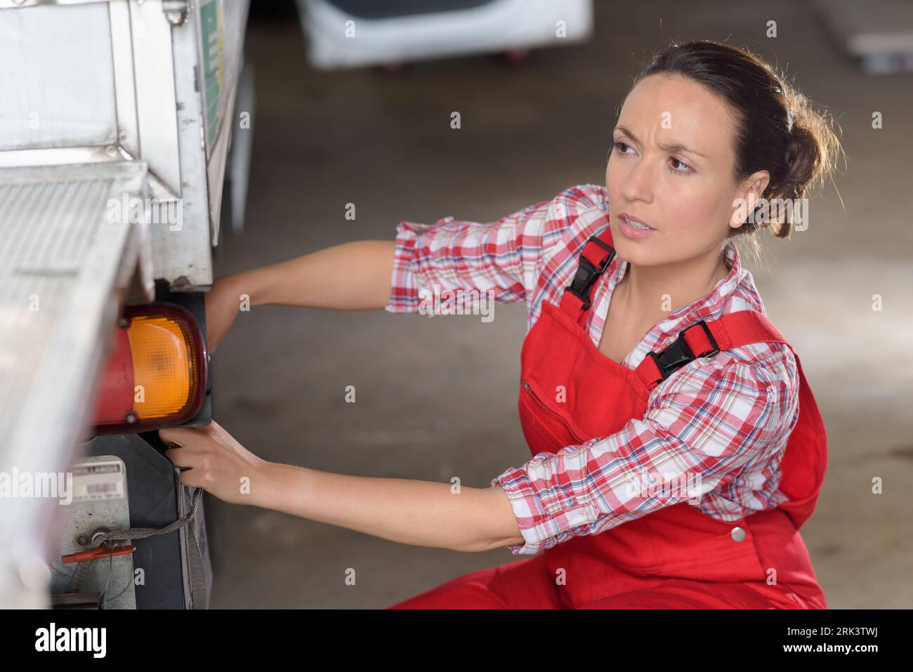 female mechanic working on industrial vehicle in garage Stock Photo - Alamy