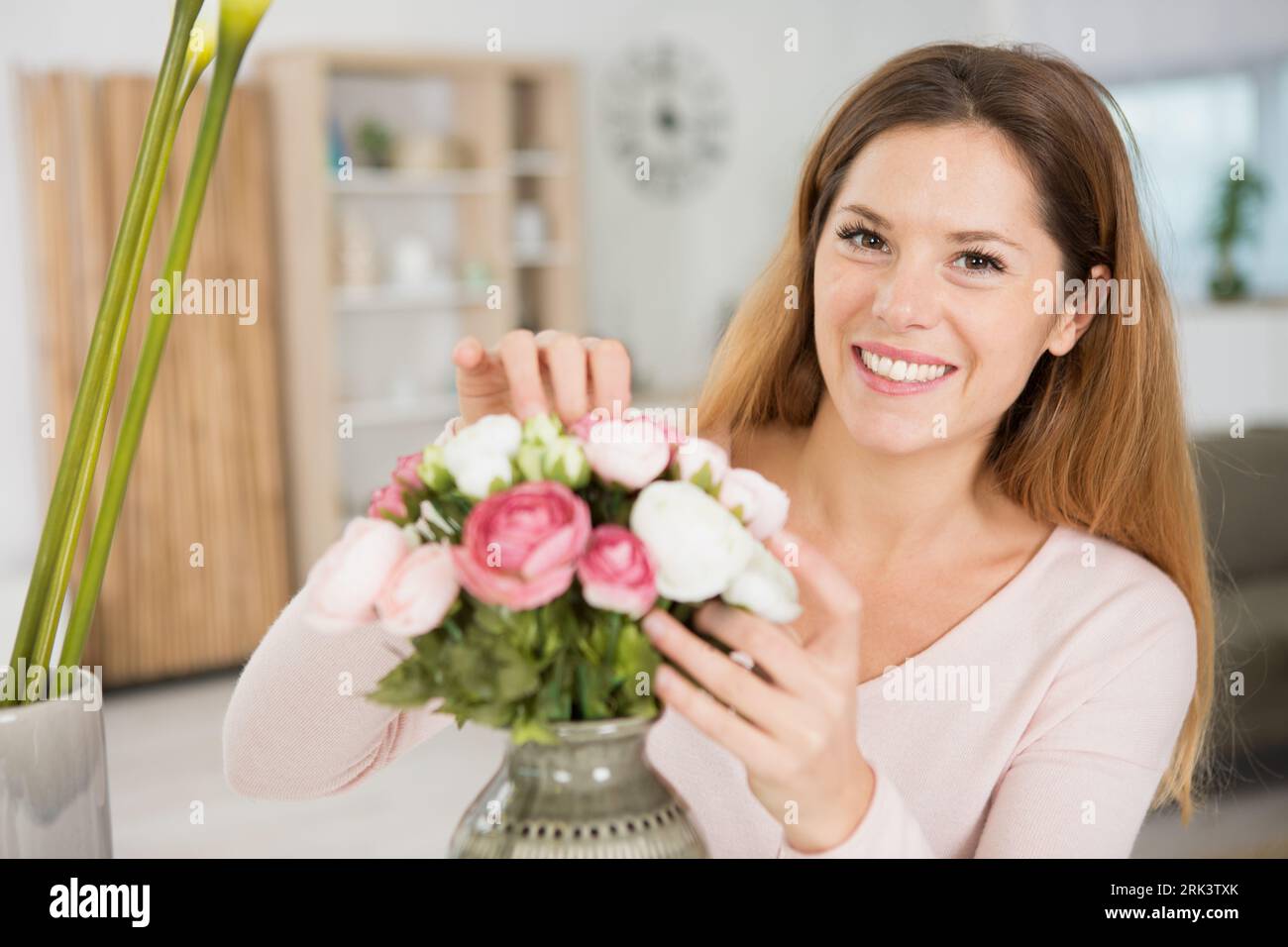 woman putting colorful flowers in a garden vase Stock Photo - Alamy