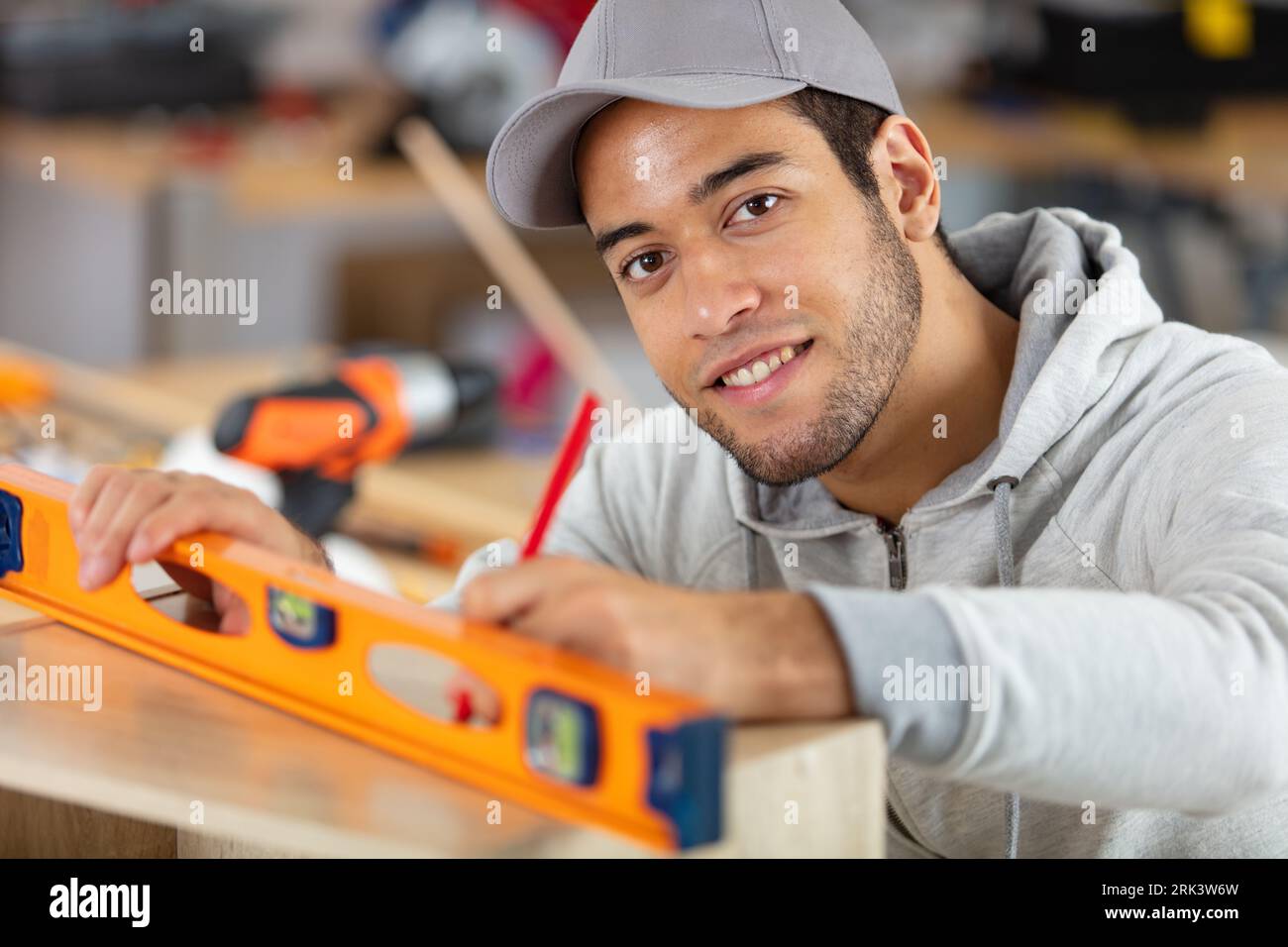 mason measuring plank of wood in workshop Stock Photo - Alamy