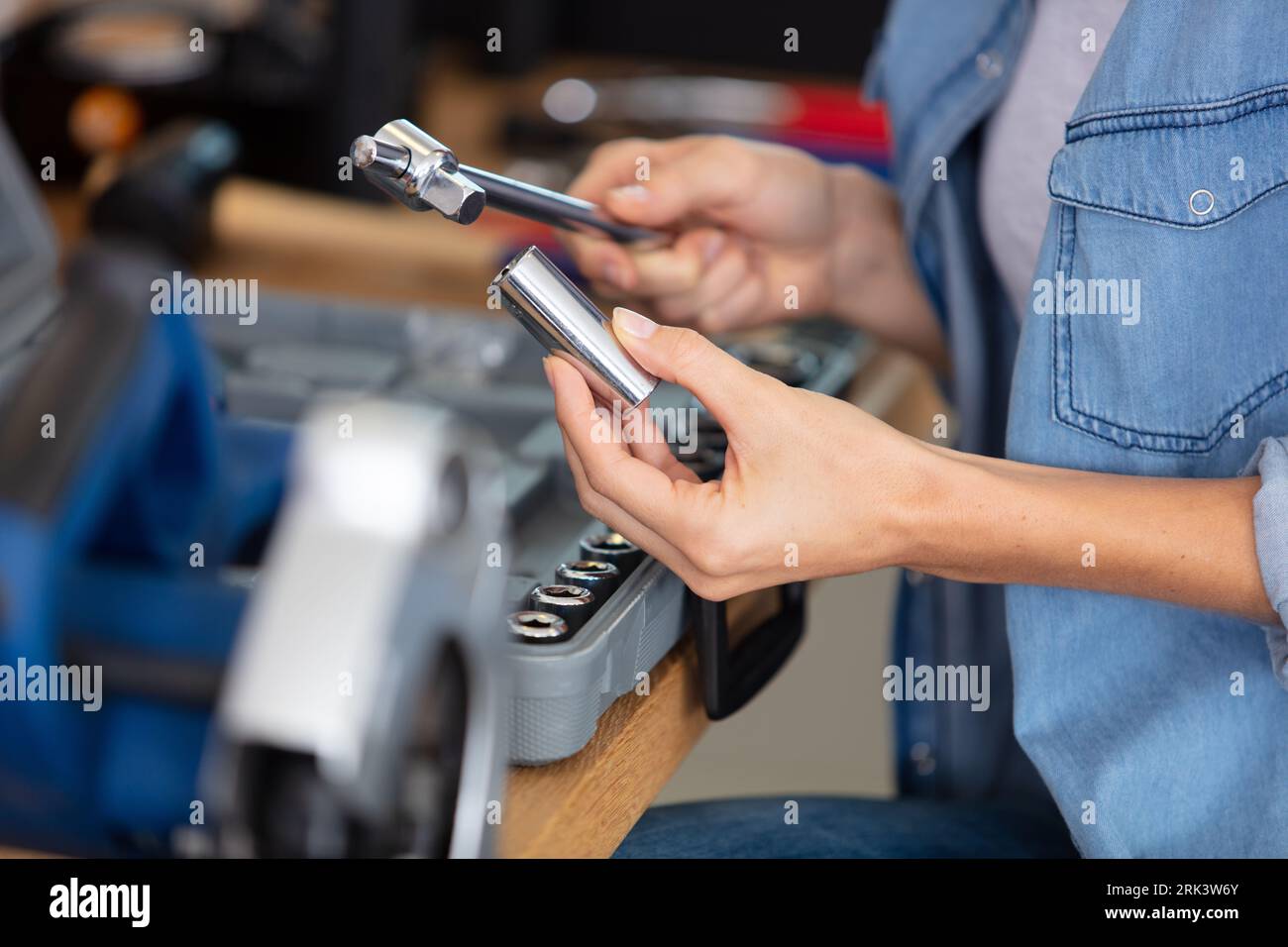 woman hand holding a spanner isolated on a white background Stock Photo ...