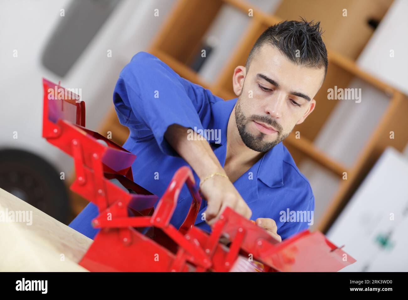 buider using a toolbox at a site Stock Photo - Alamy