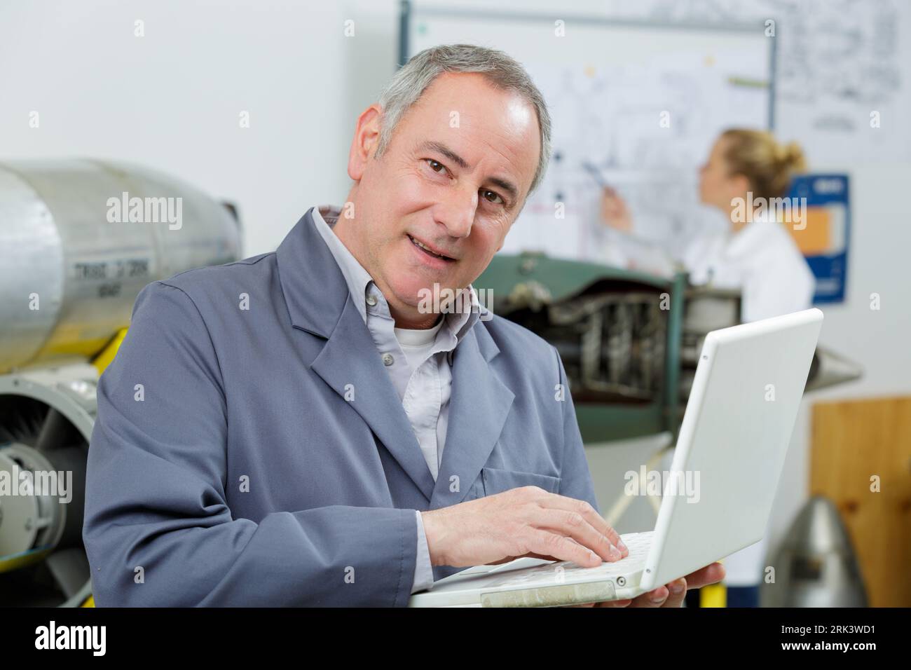 engineer handling a laptop and posing Stock Photo - Alamy