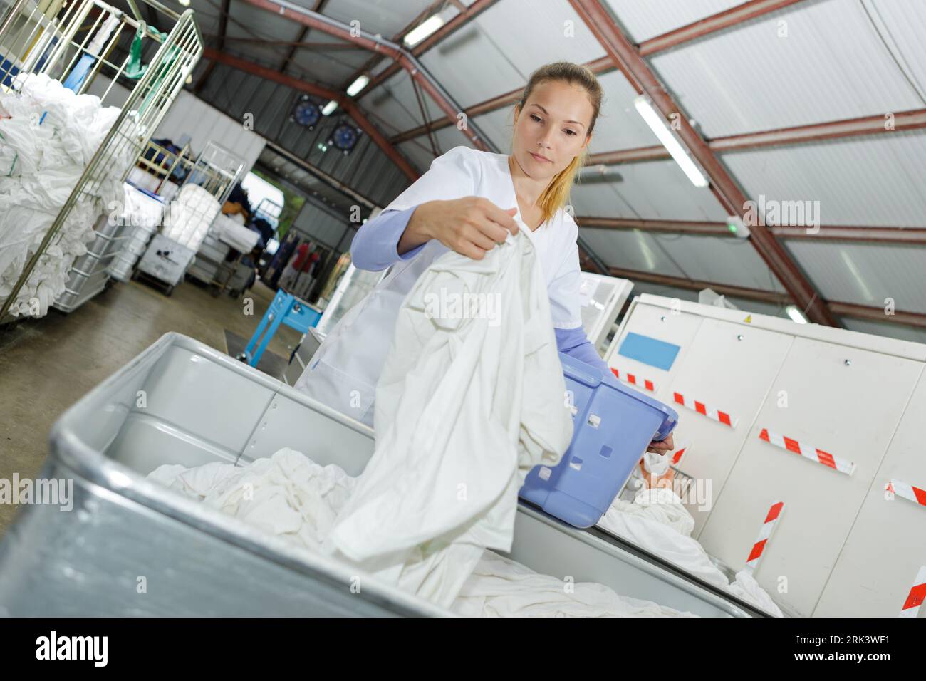 laundry worker picking up a cloth Stock Photo - Alamy