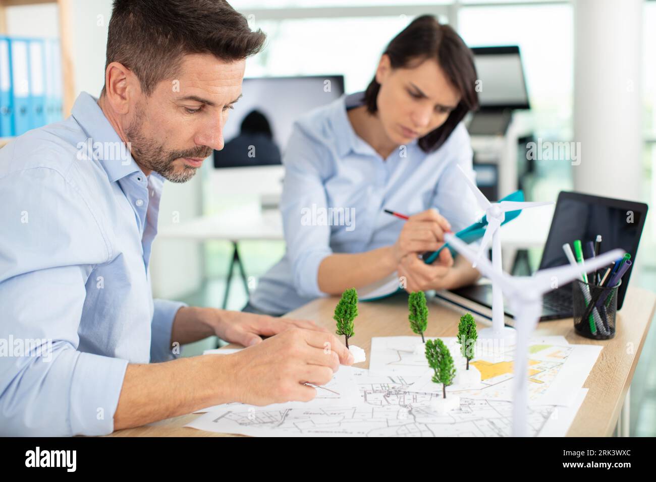 architectural team at desk working on designs Stock Photo - Alamy