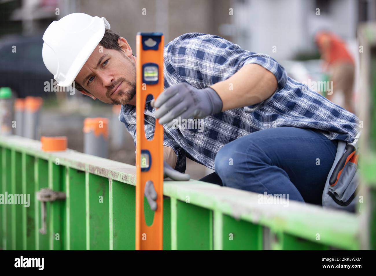 workman using spirit level on outdoor site Stock Photo - Alamy