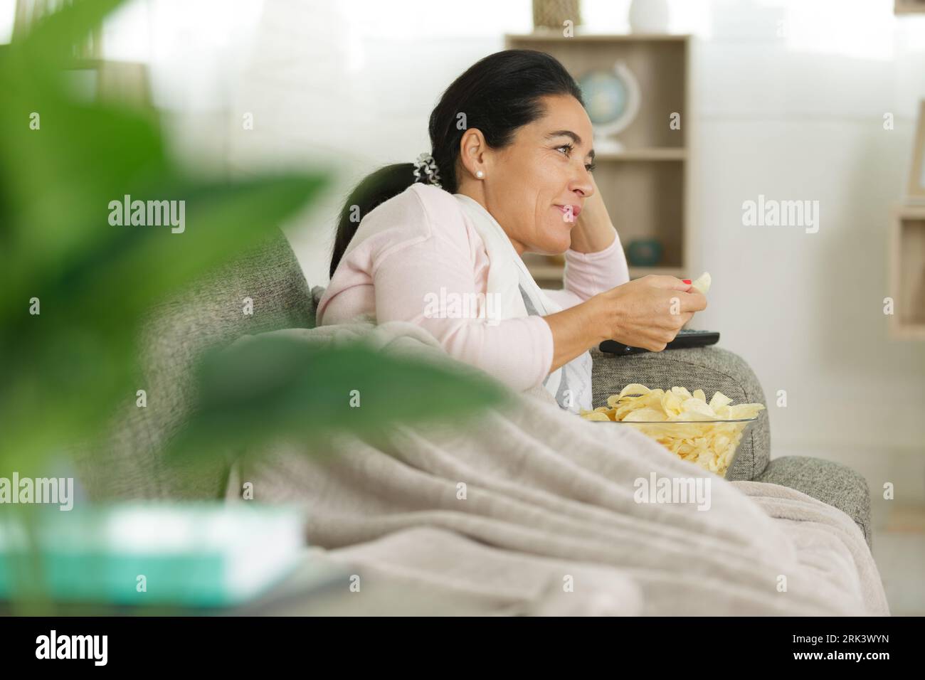 Attractive woman eating chips hi-res stock photography and images - Alamy