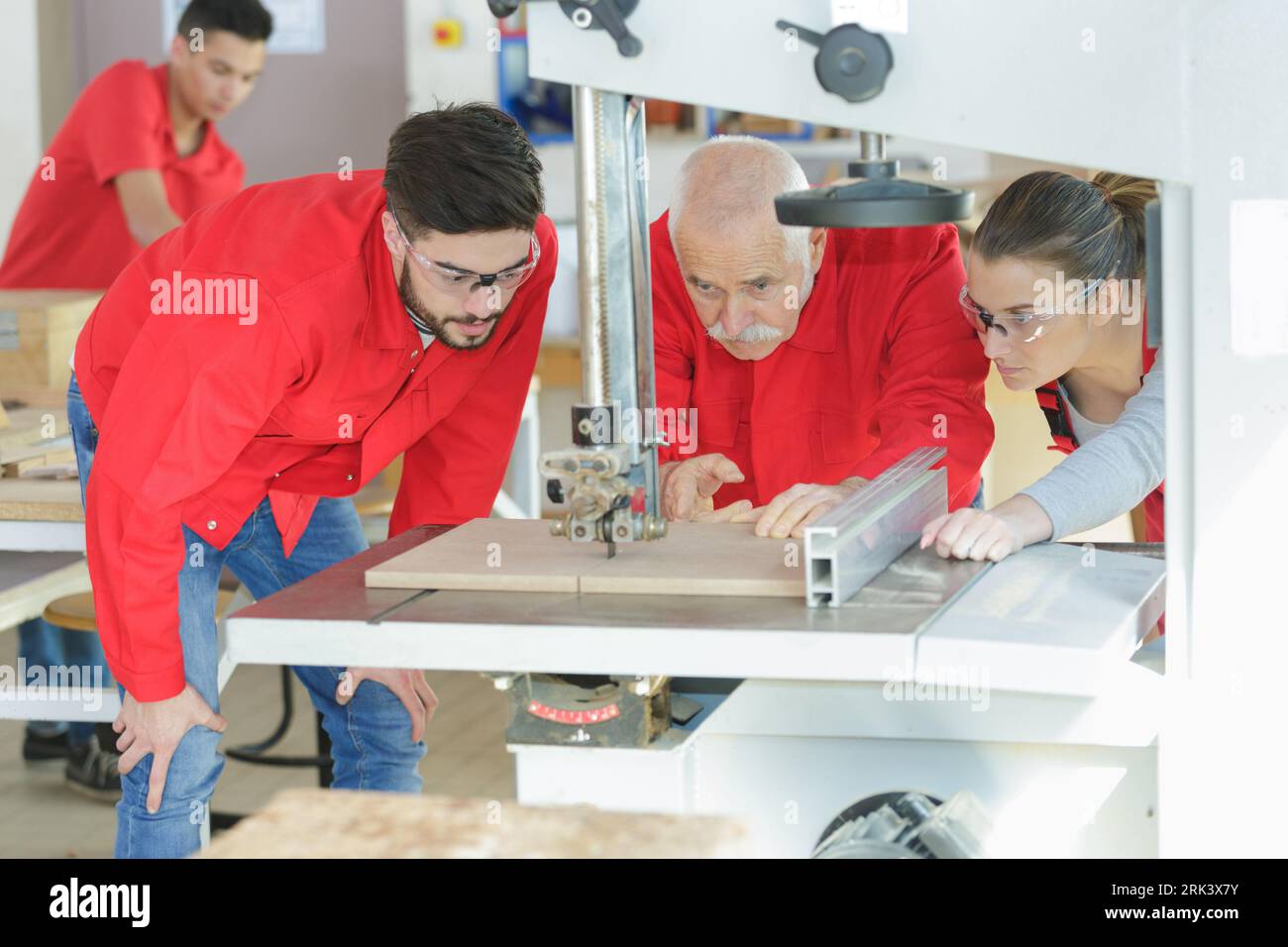 engineer and apprentices using automated milling machine Stock Photo ...