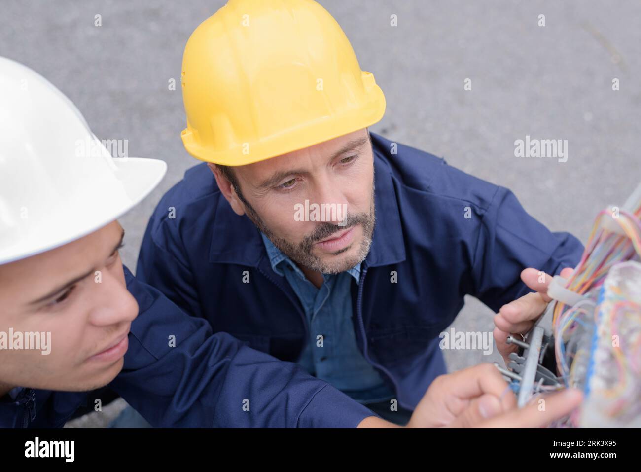 two engineers wearing hard hat discussing outdoors Stock Photo - Alamy