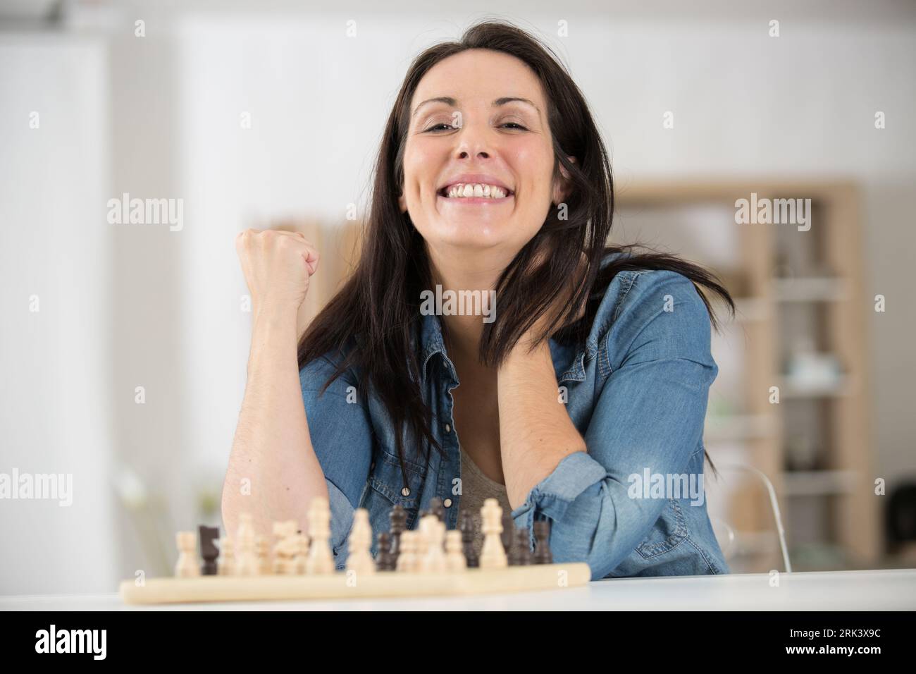 happy woman won a chess competition Stock Photo - Alamy