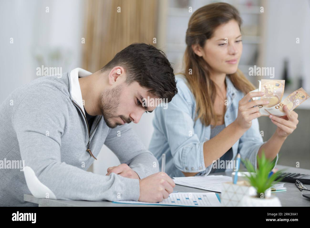 a young couple counting money Stock Photo - Alamy
