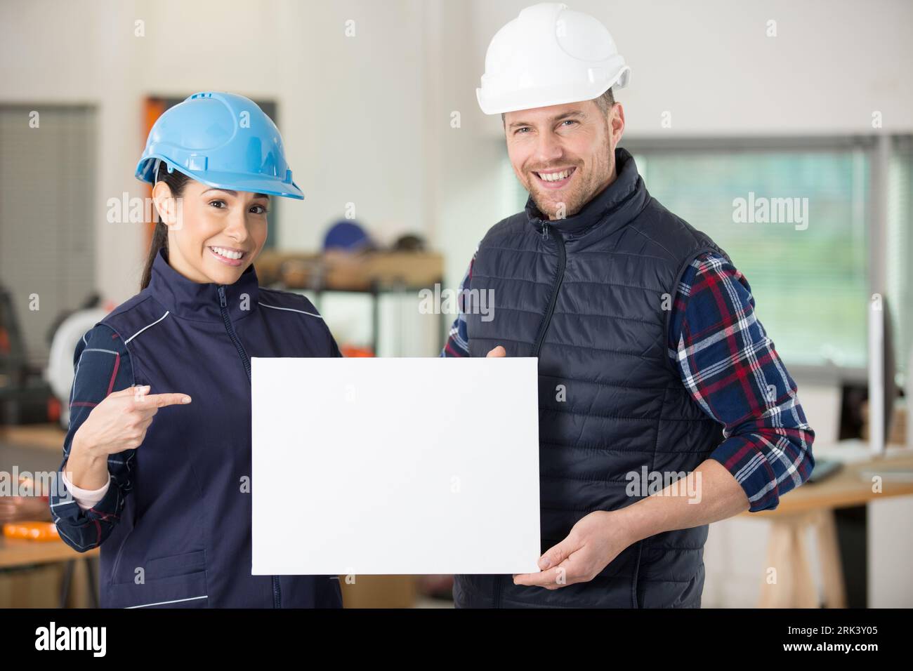 a male and a female worker showing white board Stock Photo - Alamy