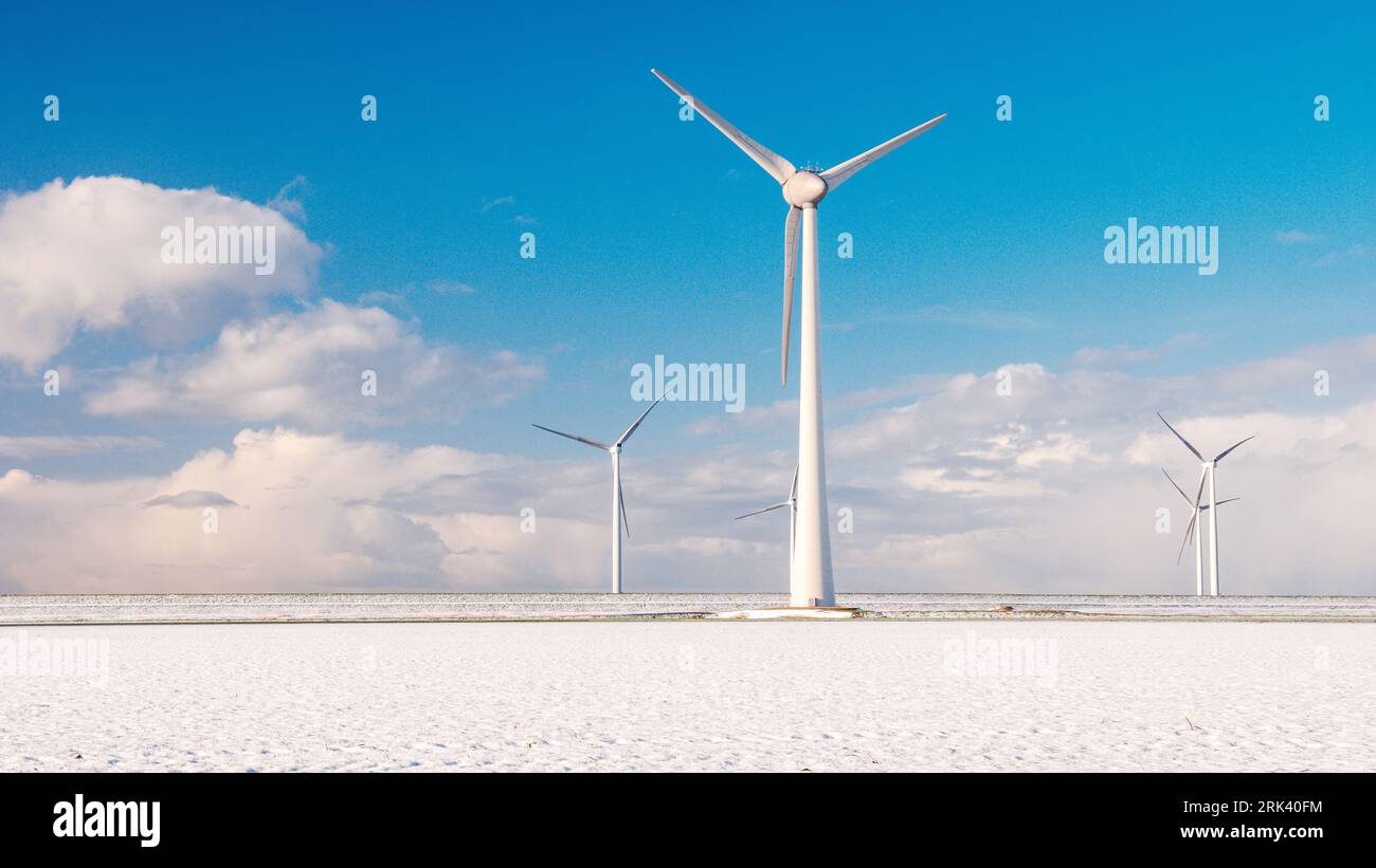 windmill park with snow during winter and a blue sky, windmill park in ...