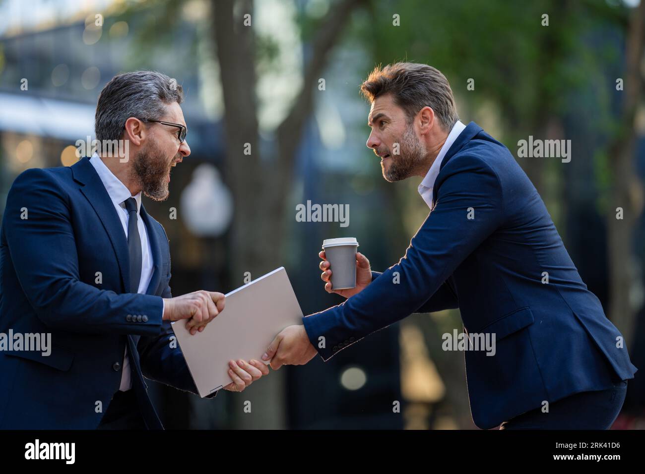Businessmen fighting outdoor. Business conflict between business men in ...