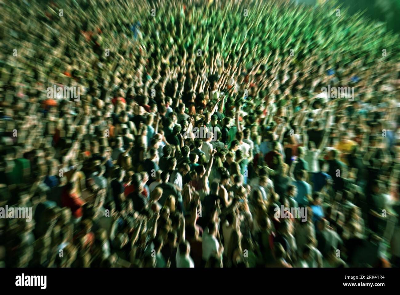 Zoom in effect on a blurred crowd partying at a music festival Stock ...