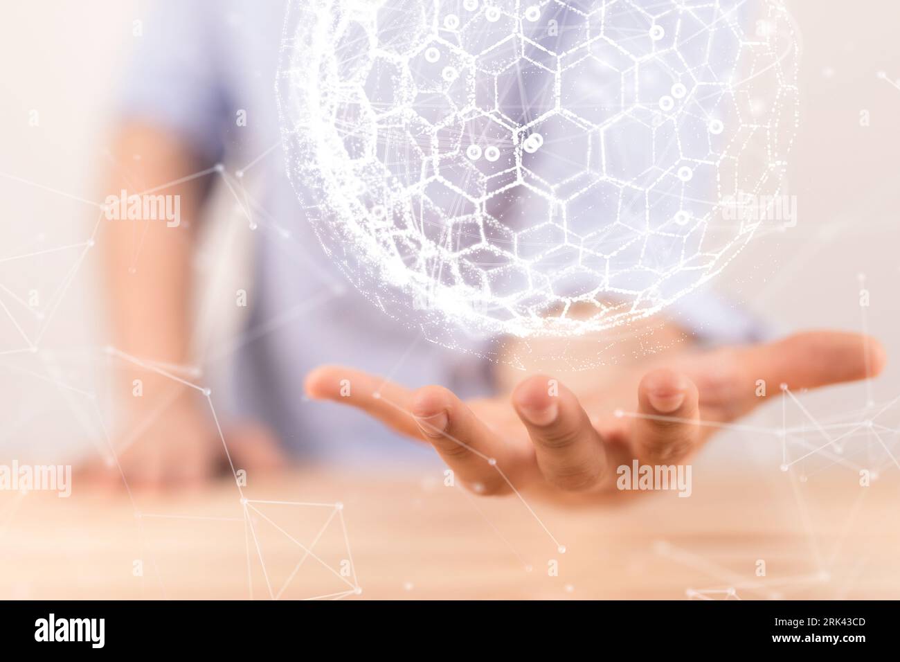 A man holding a sphere with interconnected polygons. concept of a ...