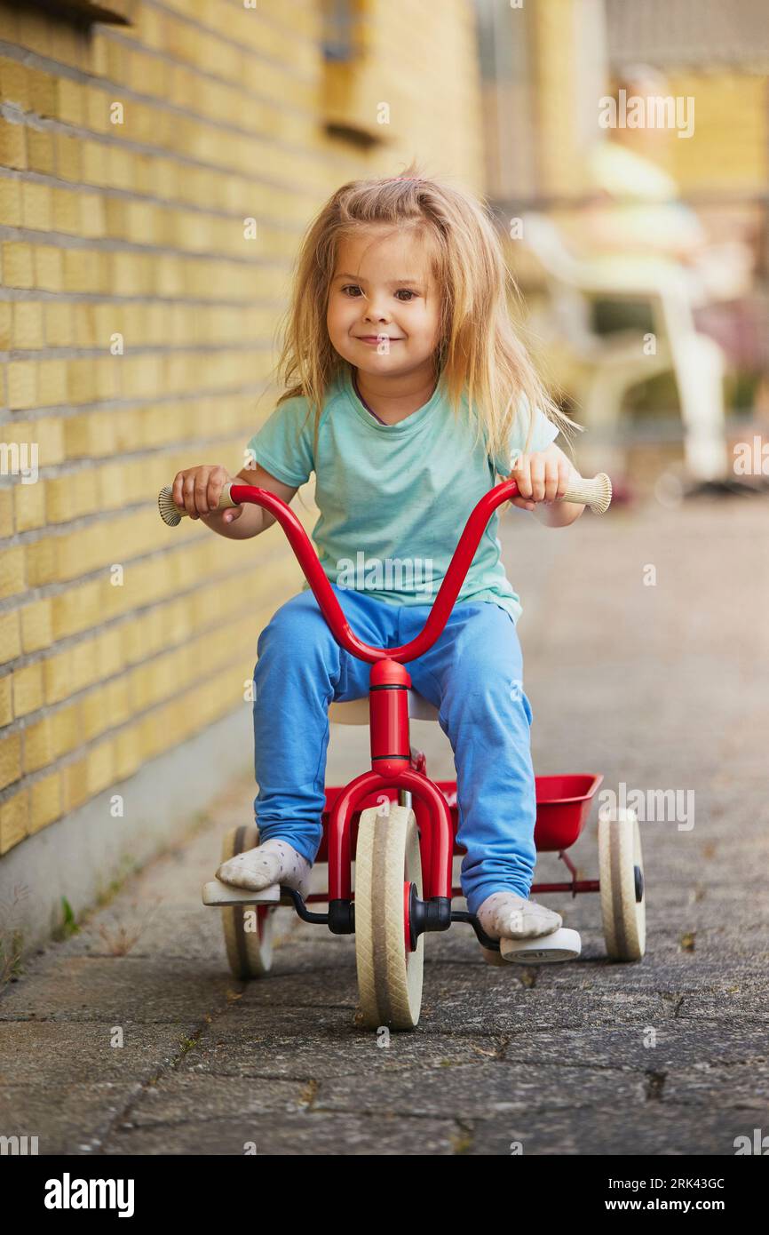 Charming blonde child rides a bicycle in Denmark Stock Photo - Alamy