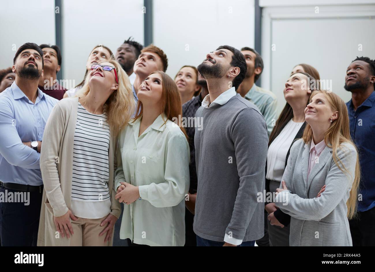 Active multiethnic male and female audience looking up Stock Photo - Alamy