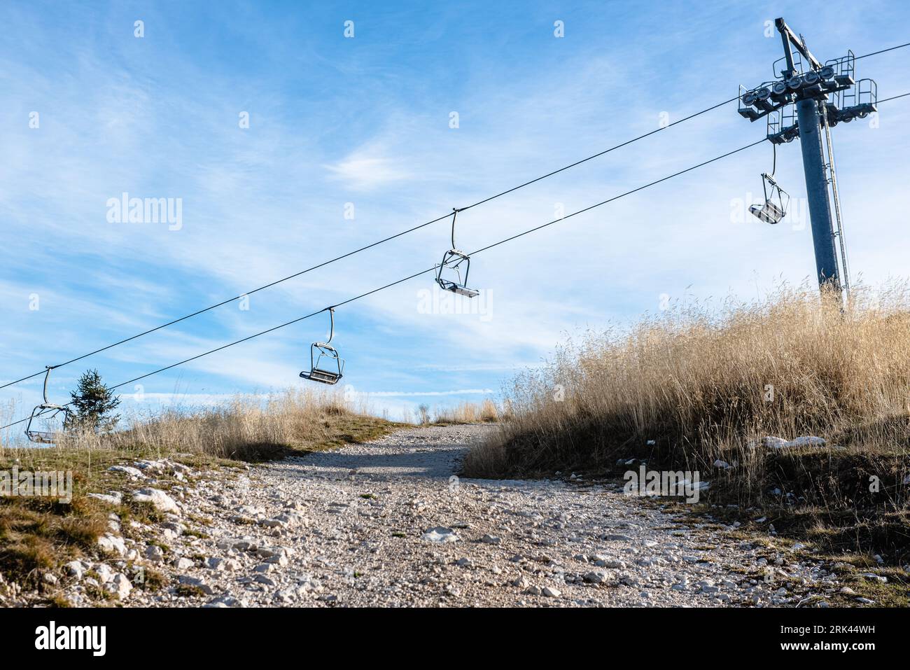 The empty ski lift above a rocky hillside landscape Stock Photo - Alamy
