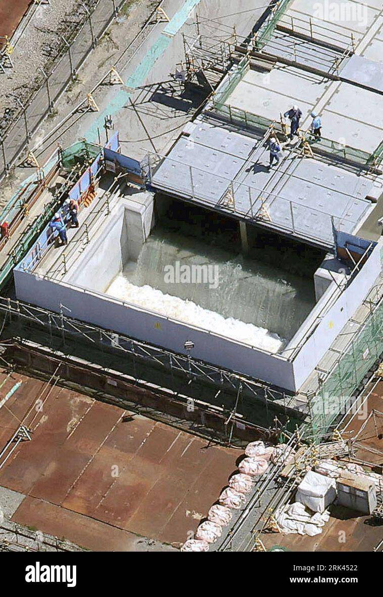 This aerial view shows the treated water diluted by seawater flowing ...