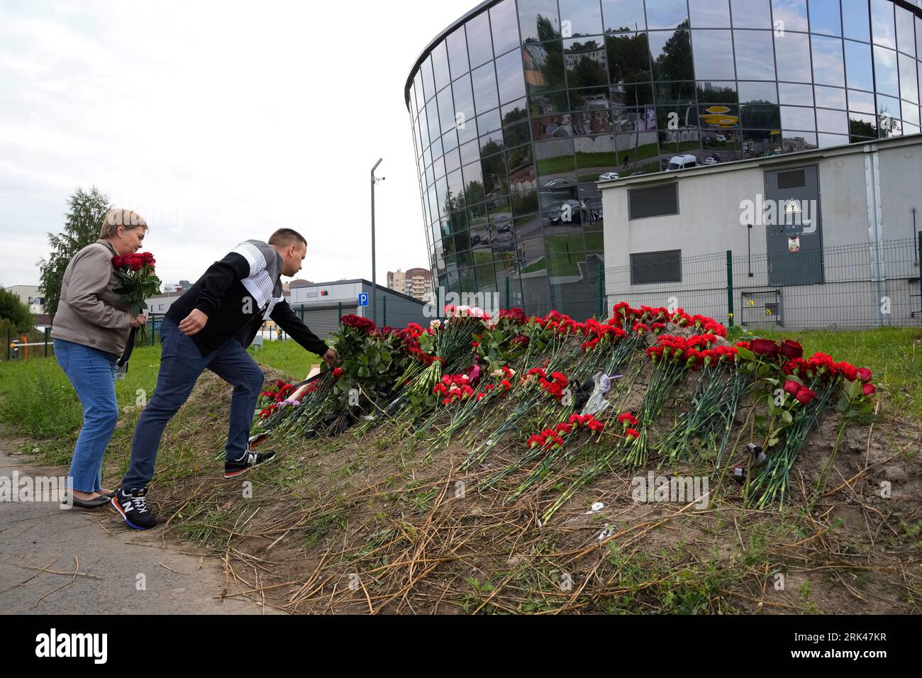 People lay flowers at an informal memorial next to the former 'PMC ...