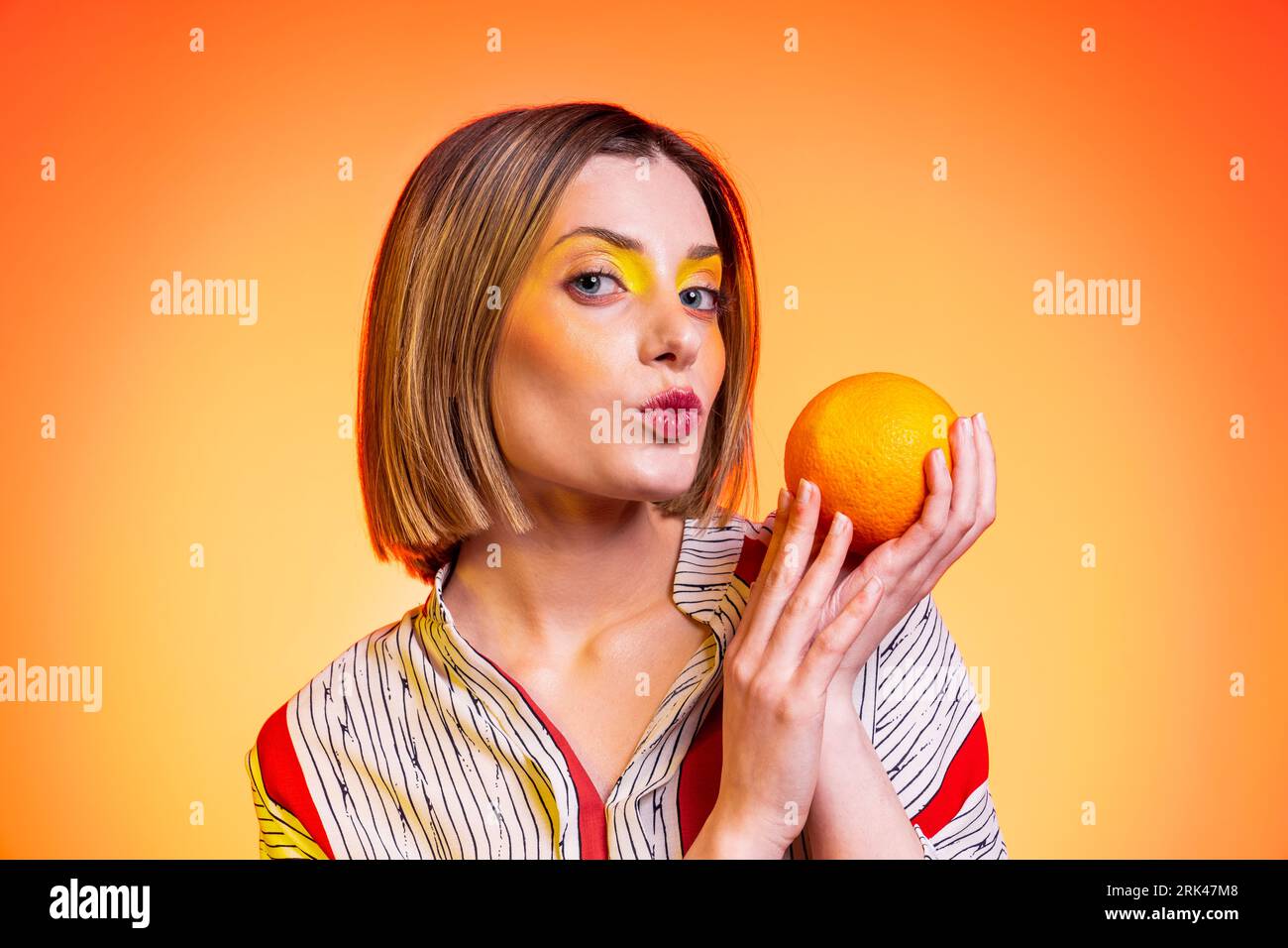 Beautiful Attractive Blond Young Woman Light Blue Eyes Holding Orange