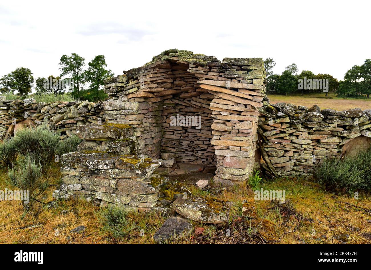 Popular architecture. Shepherd hut and drystone wall building with ...