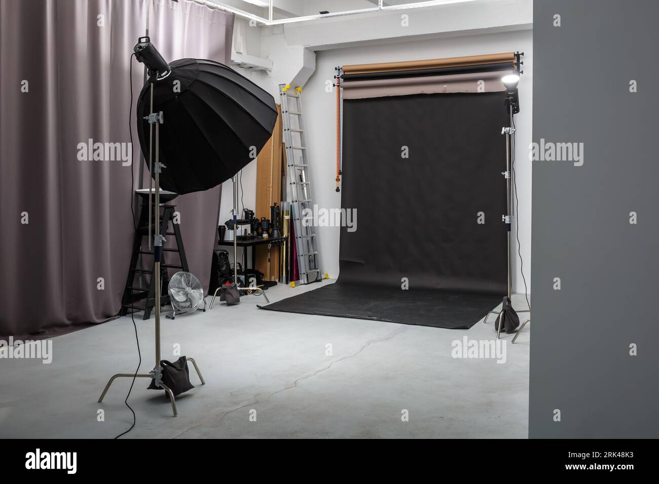 interior of bright space of photo studio with large black background ...