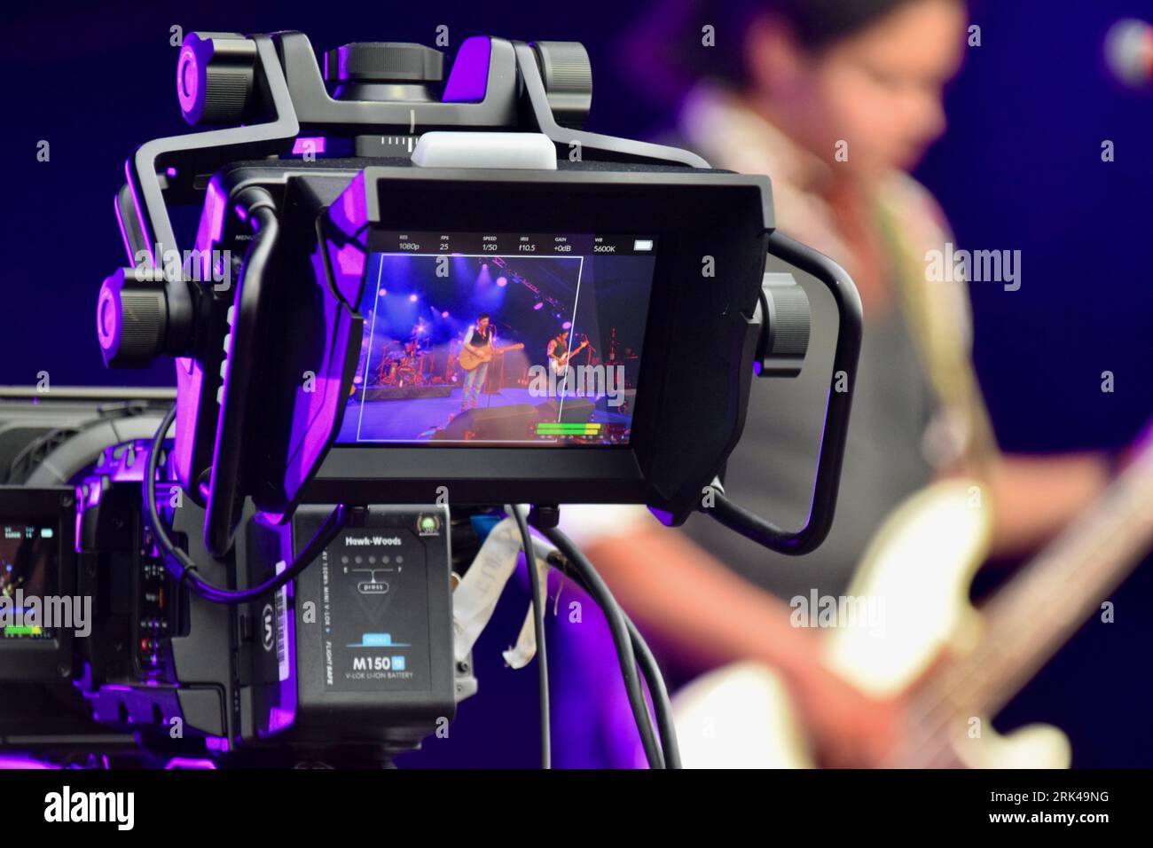 Grace Petrie at The Cambridge Folk Festival 2023 viewed through a TV ...