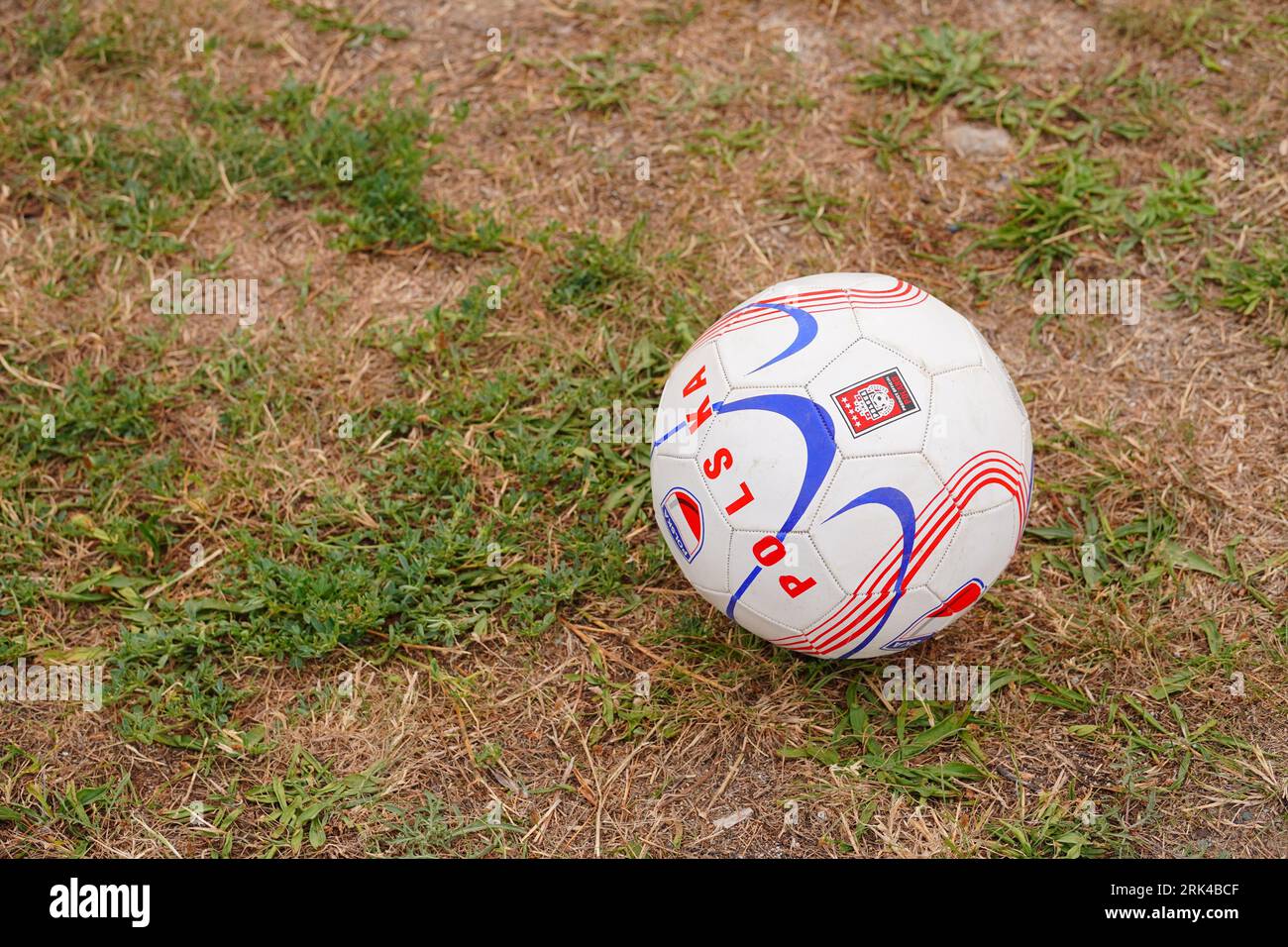 A soccer ball resting on the lush green grass of an open field Stock ...