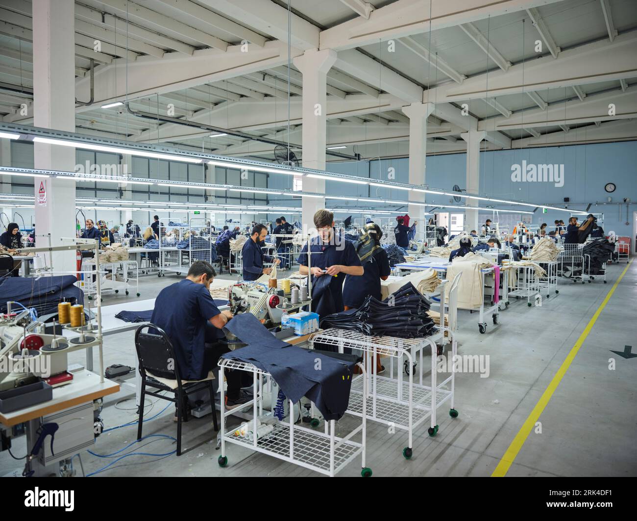 several sewing machines. Tailoring industry. jean making factory. jean ...