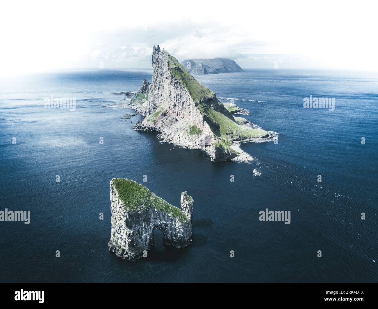 Drone shot of Drangarnir, the iconic sea stacks nestled between Tindholmur islet and Vagar ...