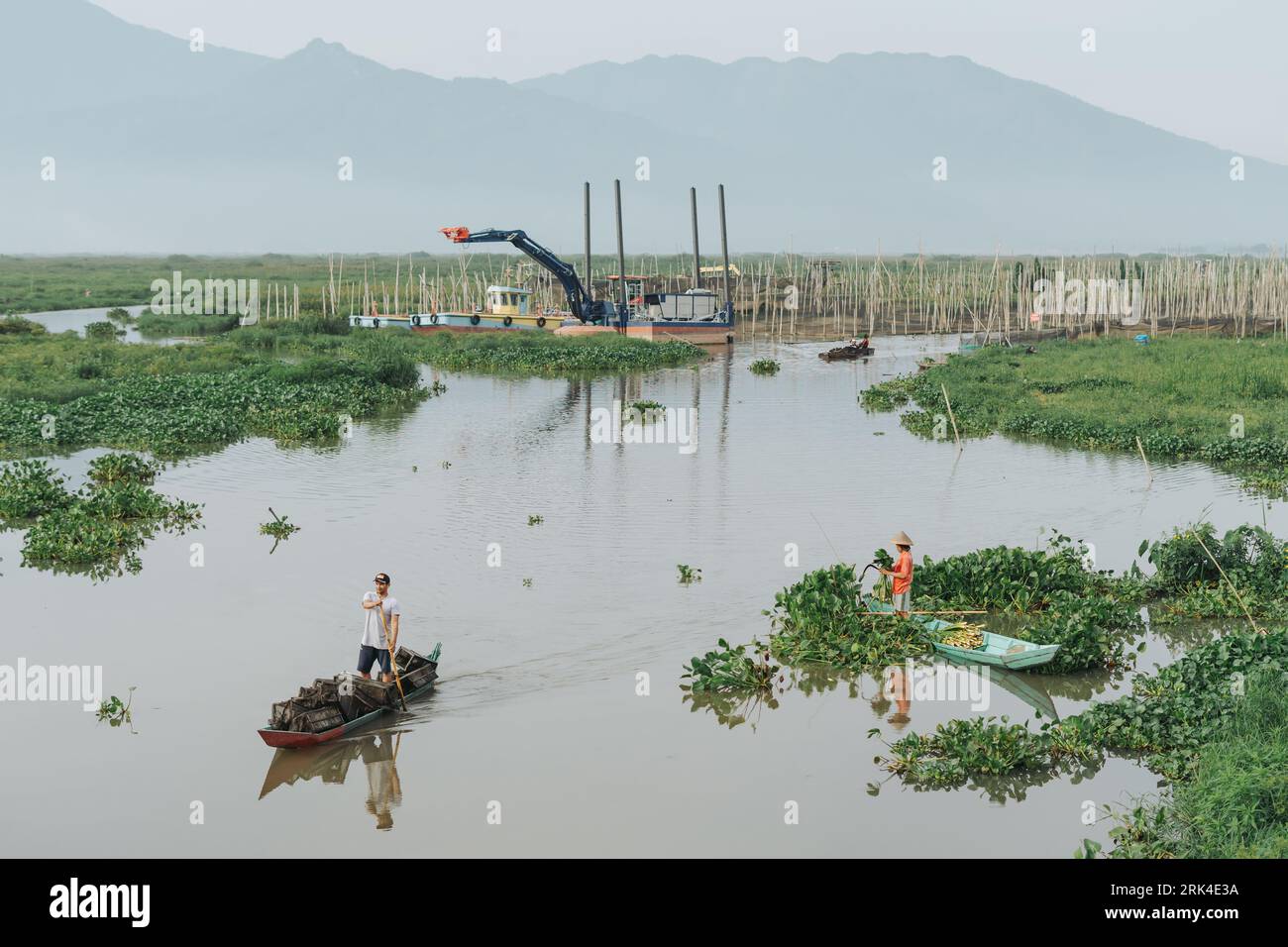 A miner transport peat soil by boat on Rawa Pening lake in Semarang ...