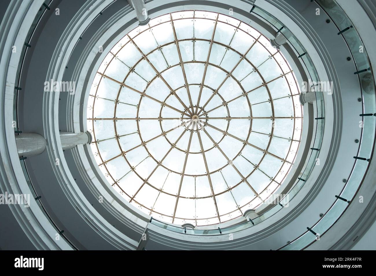A luxurious architectural room featuring a large round window roof ...