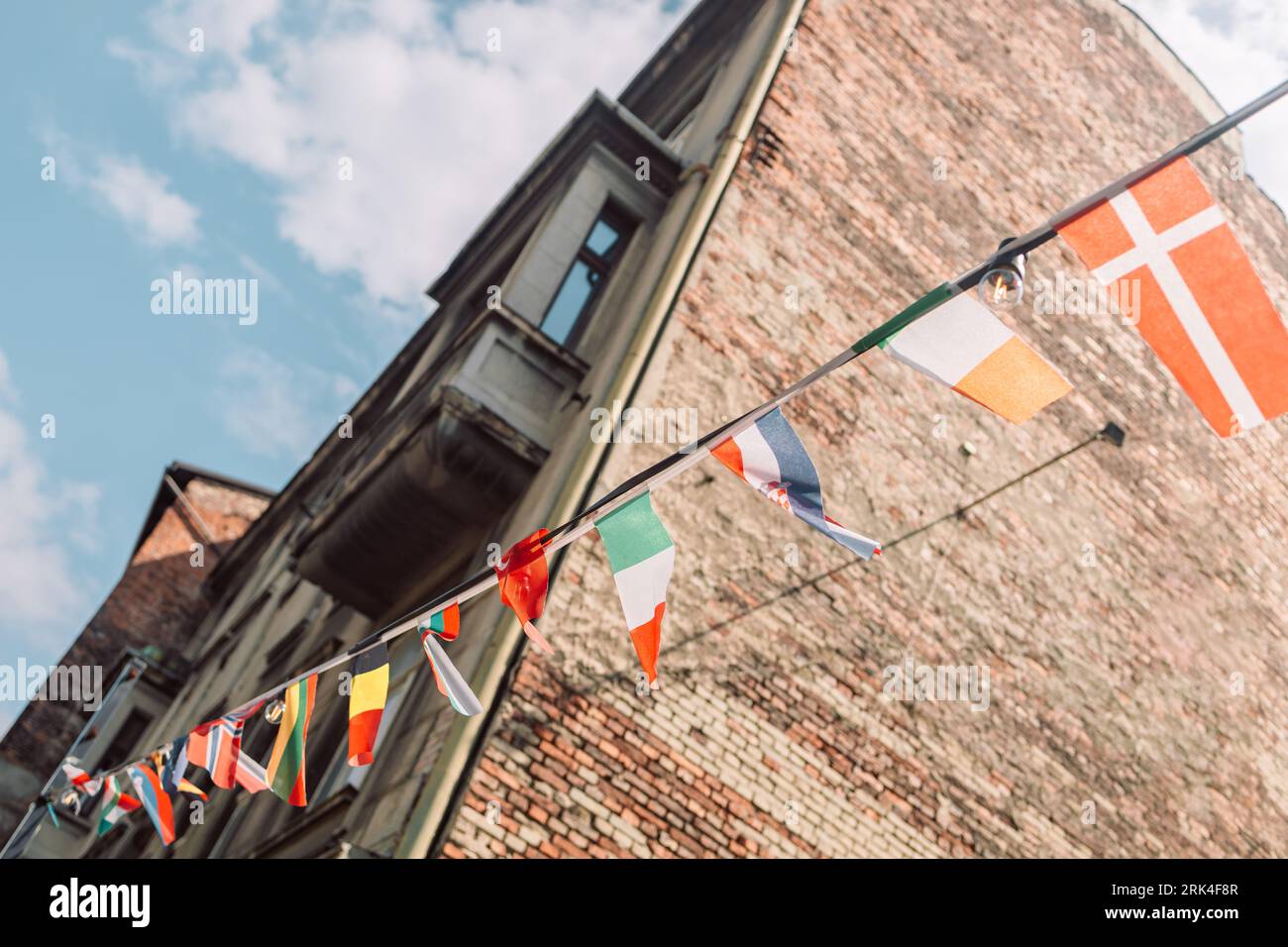 Many countries flags hanging from a ceiling on ropes at summer time ...