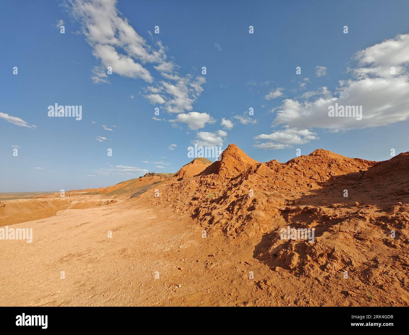 An expansive desert landscape featuring rock formations and jagged ...