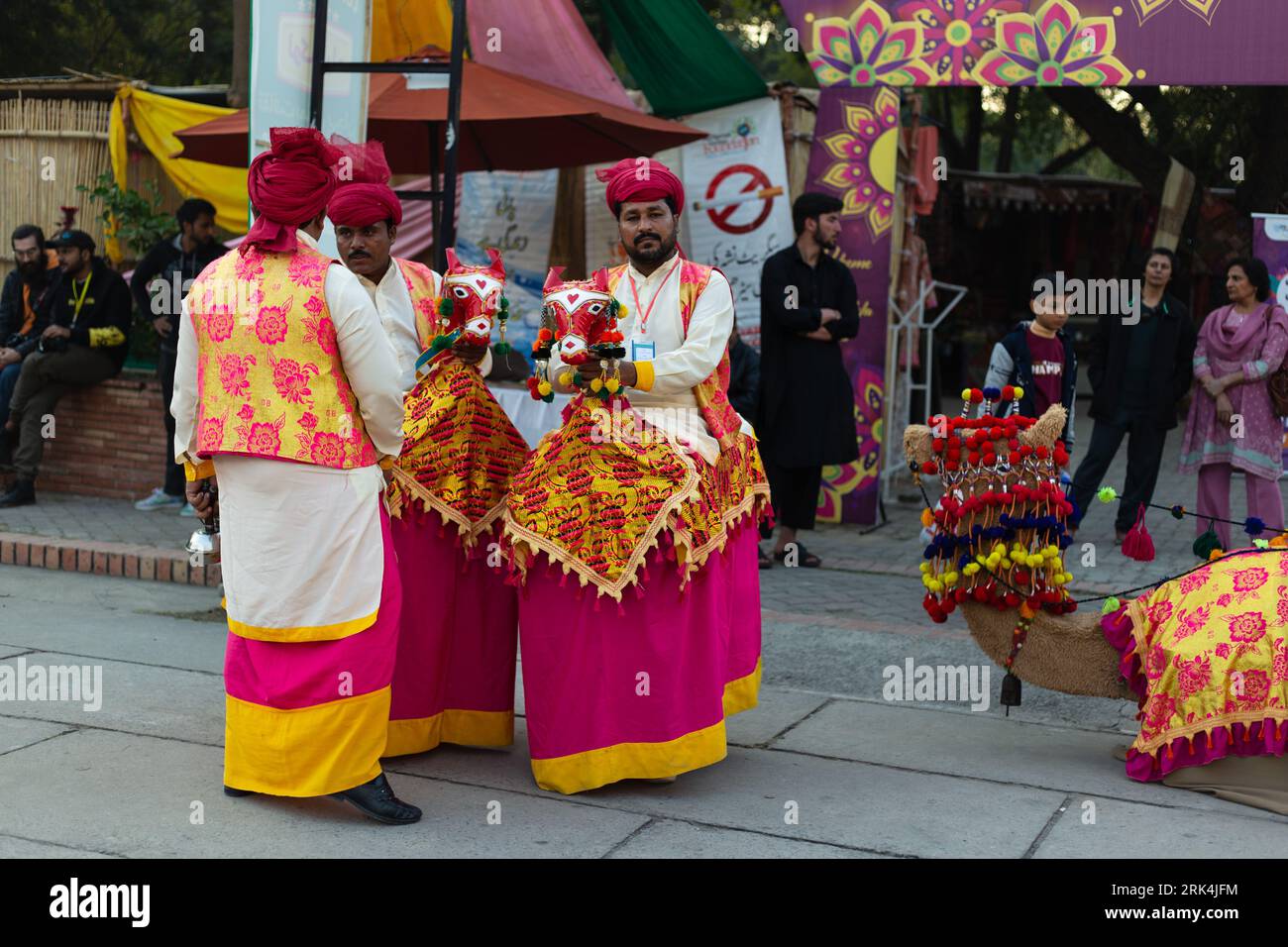 A group of performers dressed in vibrant, traditional attire during the ...