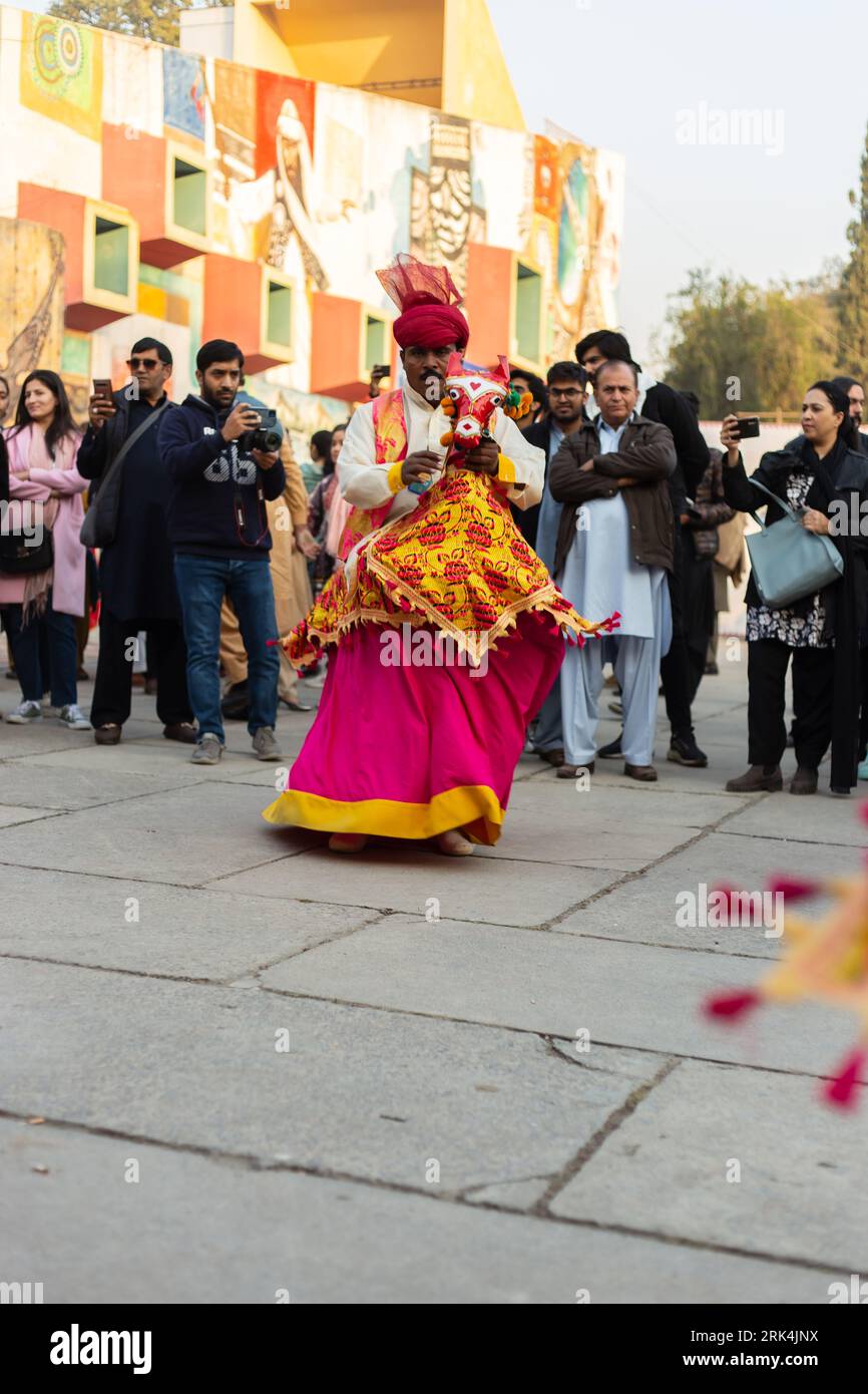 A performer wearing traditional clothing during the Lok Mela festival ...
