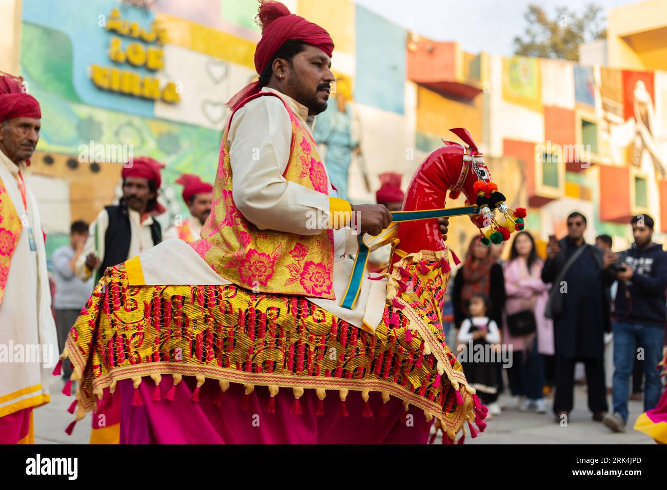 A man in traditional attire performing during the Lok Mela festival ...