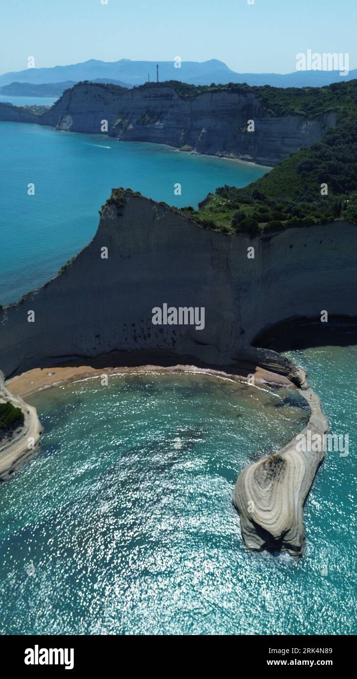 An aerial view of the rocky shoreline of Corfu, Greece with its crystal ...