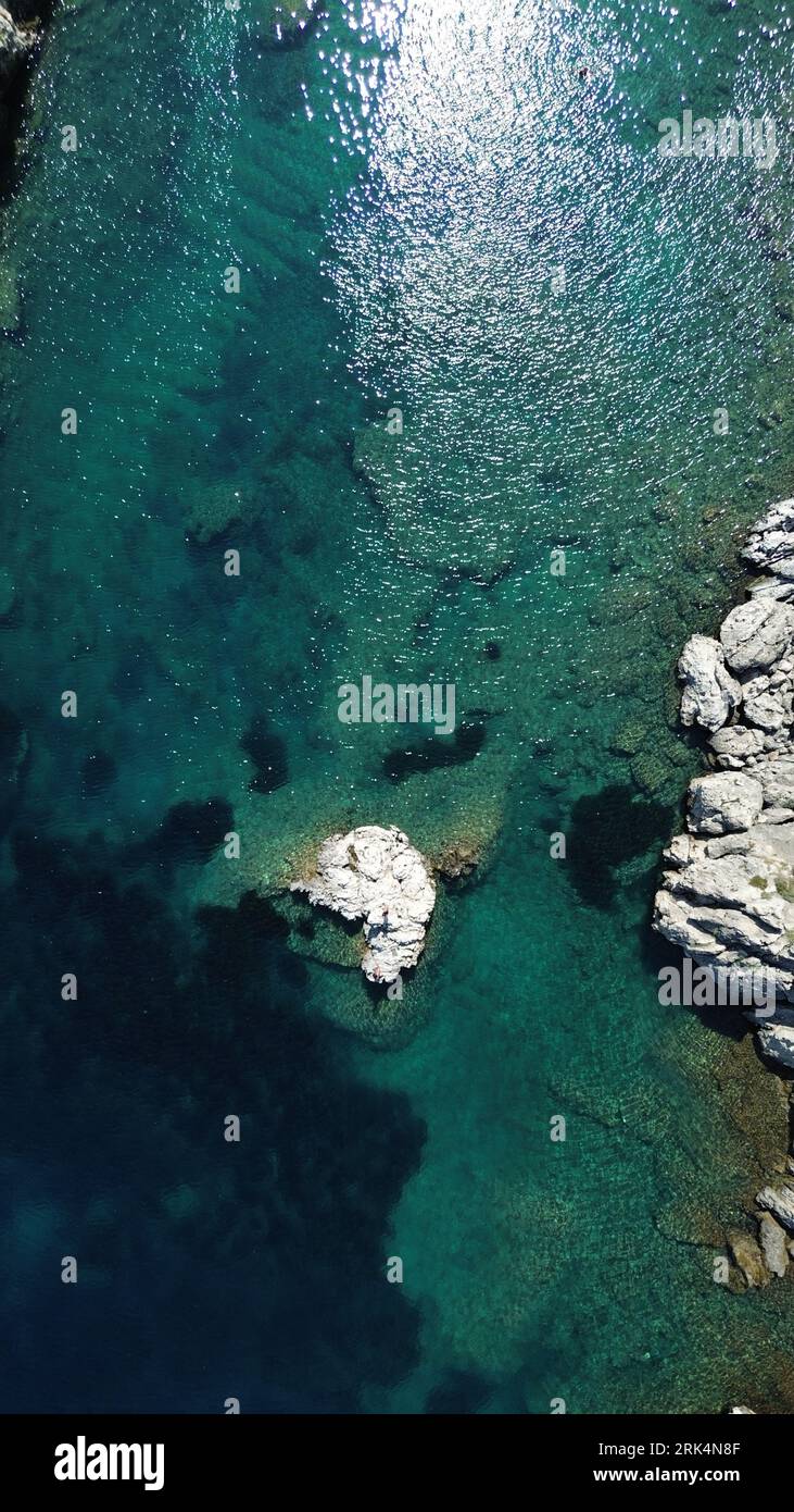 An aerial view of the rocky shoreline of Corfu, Greece with its crystal ...