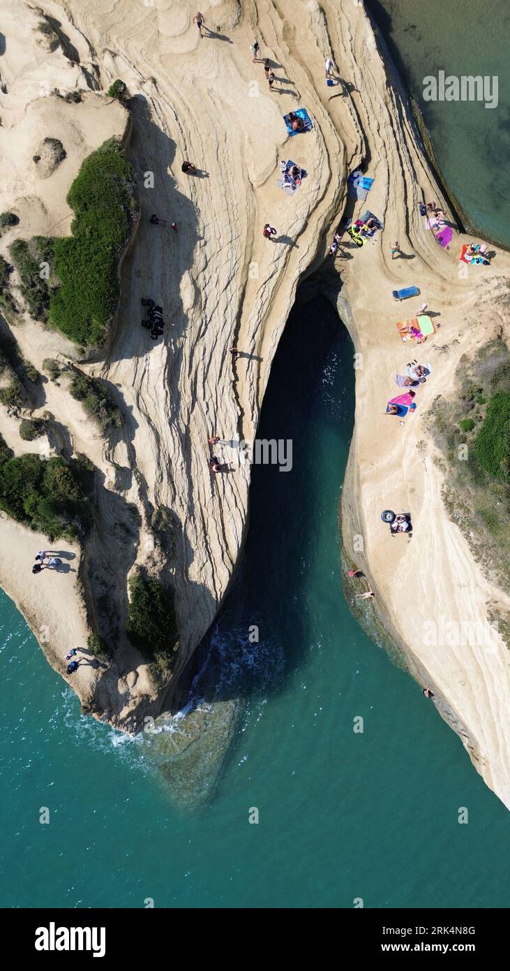 An aerial view of the rocky shoreline of Corfu, Greece with its crystal ...