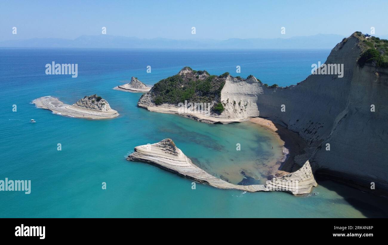 An aerial view of the rocky shoreline of Corfu, Greece with its crystal ...