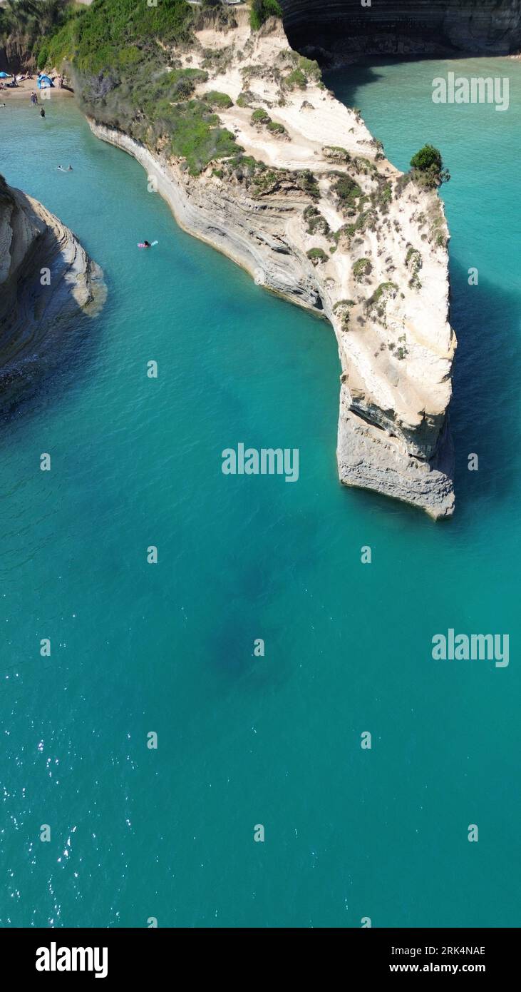 An aerial view of the rocky shoreline of Corfu, Greece with its crystal ...