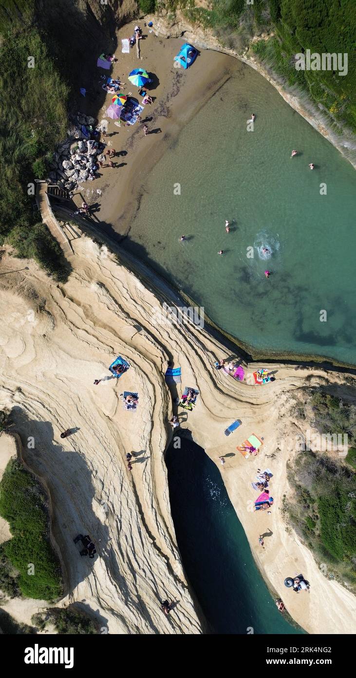 An aerial view of the rocky shoreline of Corfu, Greece with its crystal ...