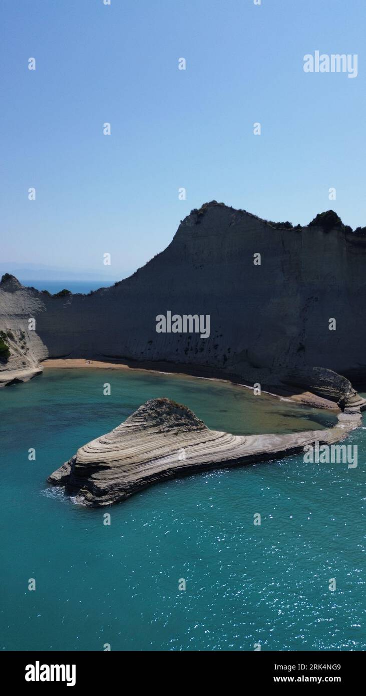 An aerial view of the rocky shoreline of Corfu, Greece with its crystal ...