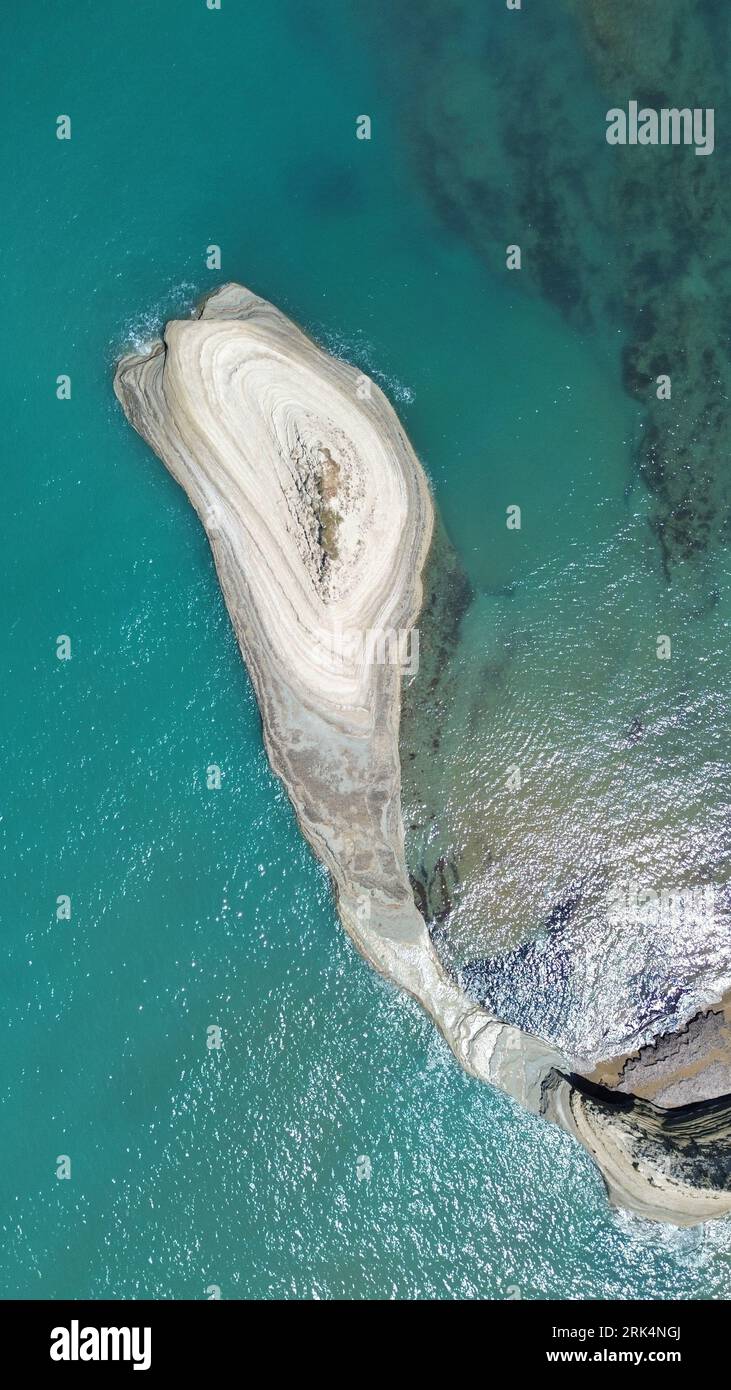 An aerial view of the rocky shoreline of Corfu, Greece with its crystal ...