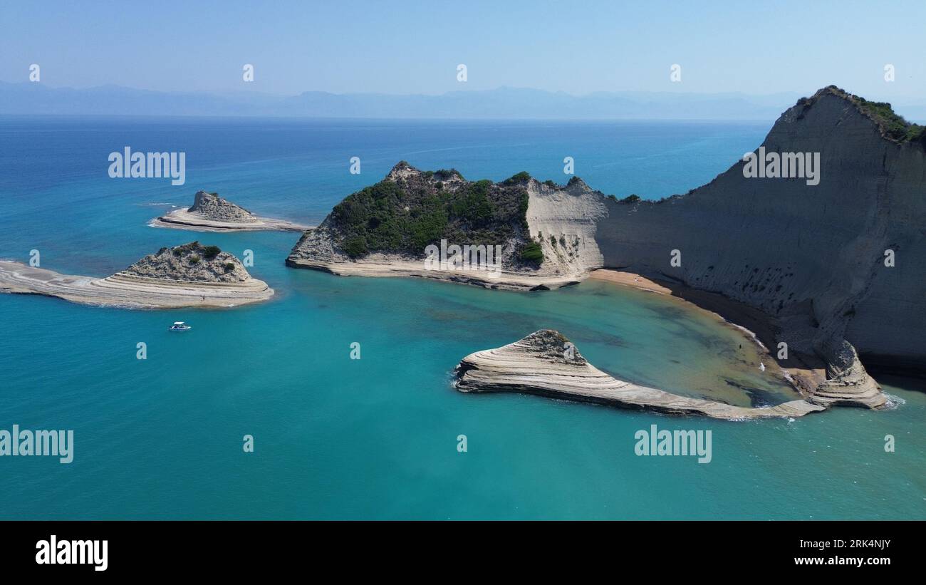 An aerial view of the rocky shoreline of Corfu, Greece with its crystal ...