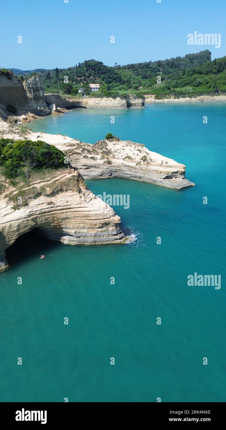 An aerial view of the rocky shoreline of Corfu, Greece with its crystal ...