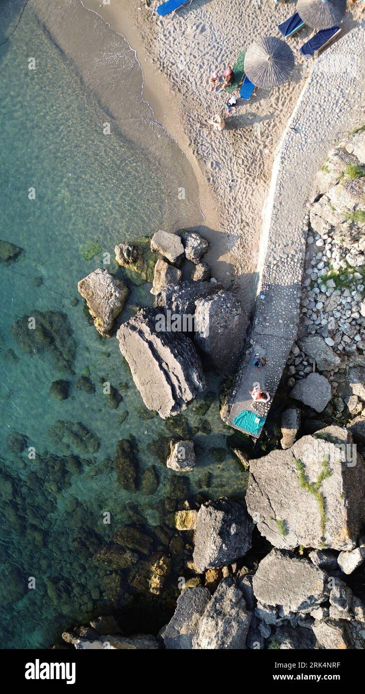 An aerial view of the rocky shoreline of Corfu, Greece with its crystal ...